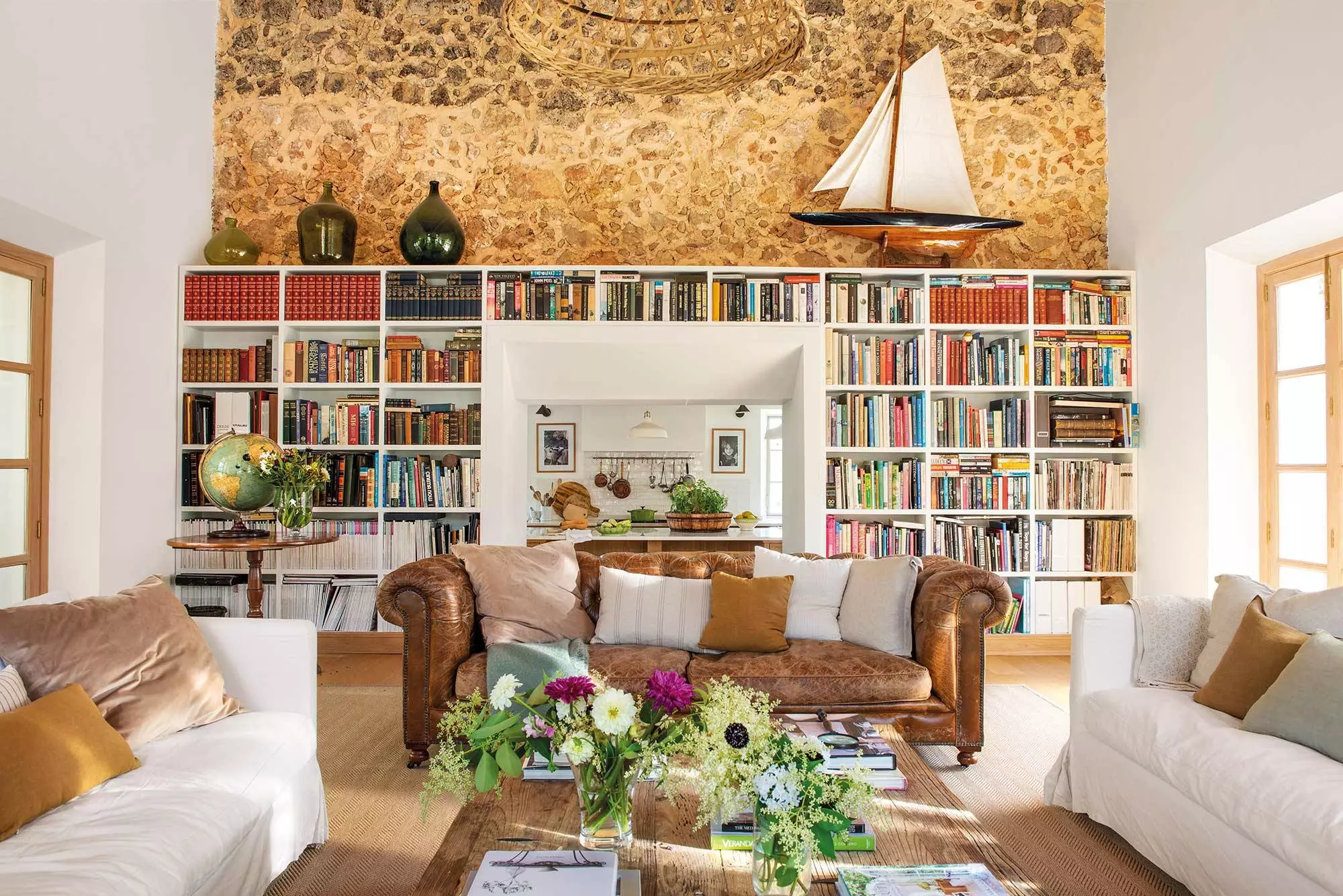 living room with wall to wall bookcase flanking door and leather chesterfield sofa 00528598