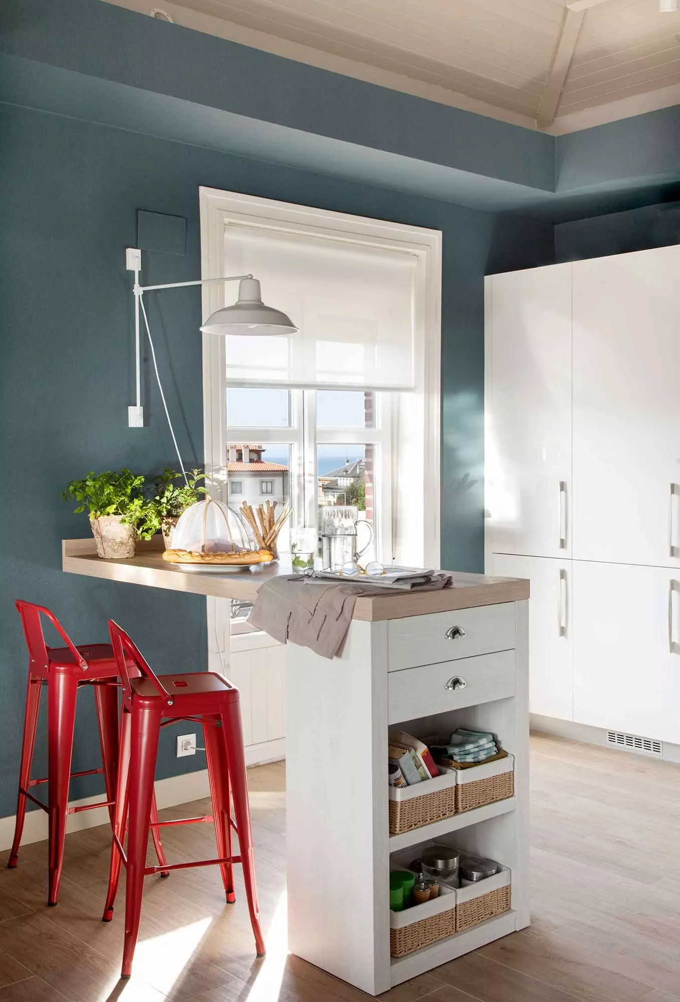 White kitchen with peninsula type office and blue wallpaper walls 00511452 O