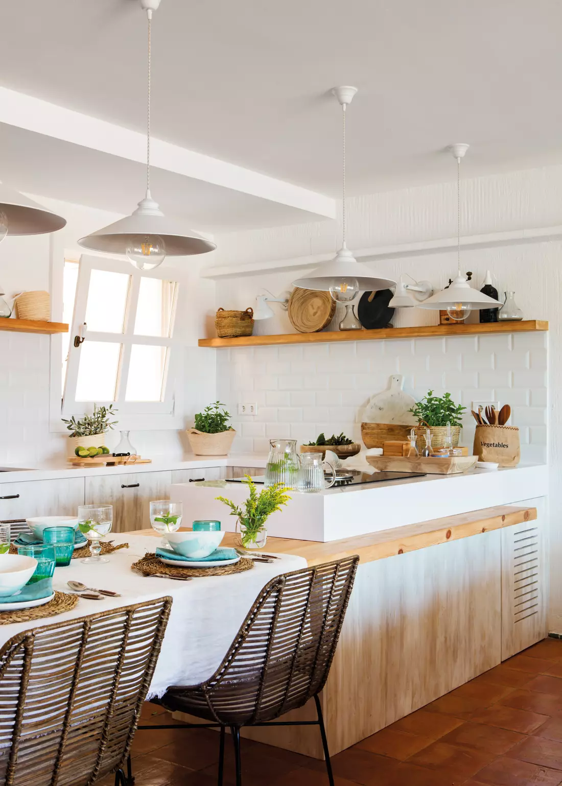 White kitchen with peninsula and attached wooden table