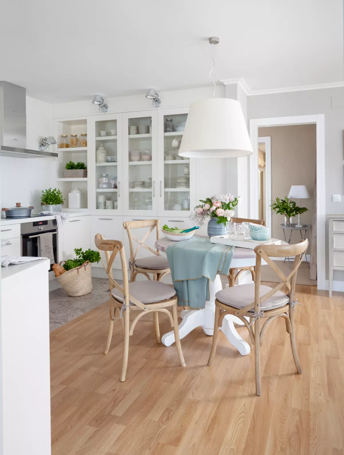 White kitchen with office with round table