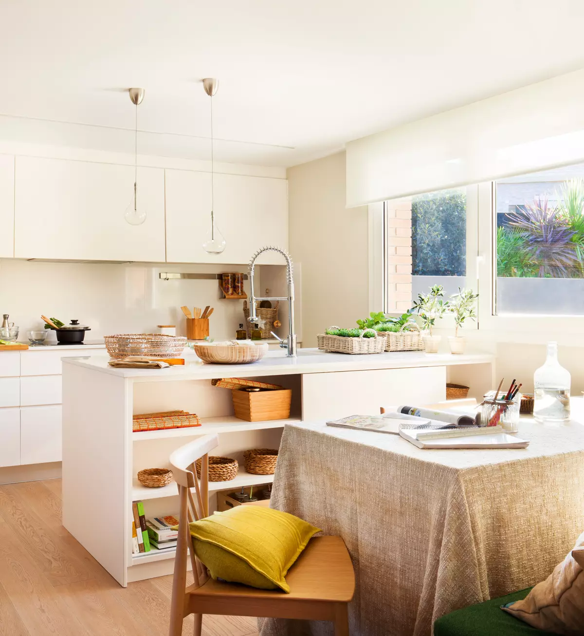 White kitchen with peninsula that separates from the office area