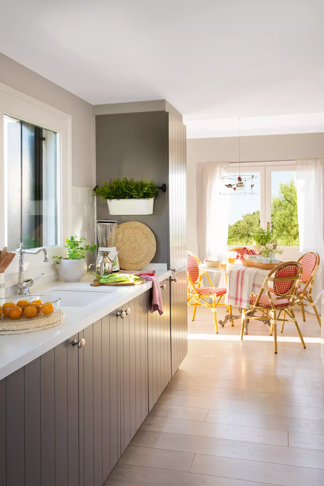 Kitchen with gray furniture and office next to window with red upholstered chairs