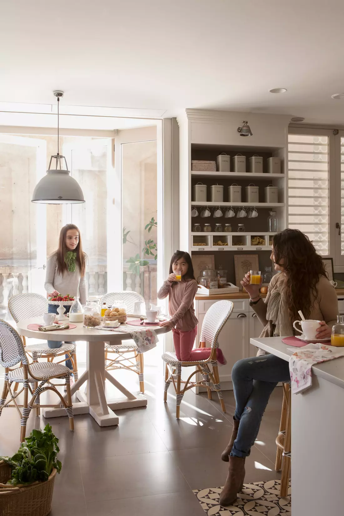 Kitchen with office with round table and woman and two girls