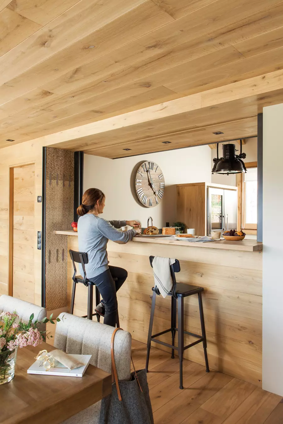 Kitchen with wooden serving hatch that is a bar