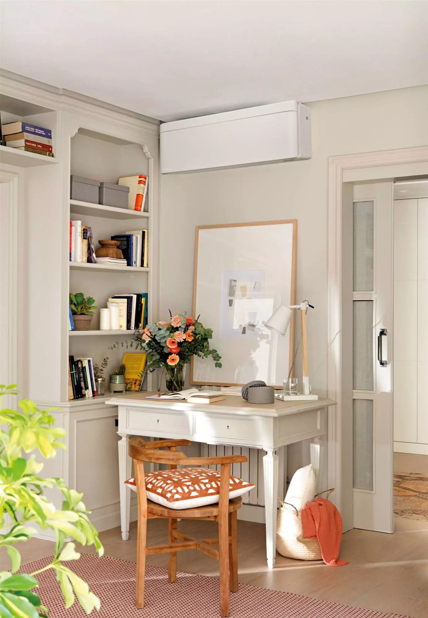 Work area with desk and chair next to bespoke gray bookcase with moldings 510209