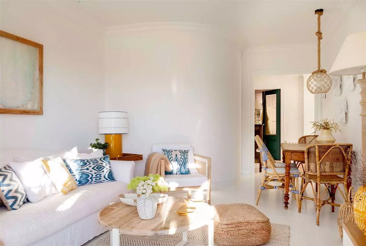 White living room with mini dining area against the wall