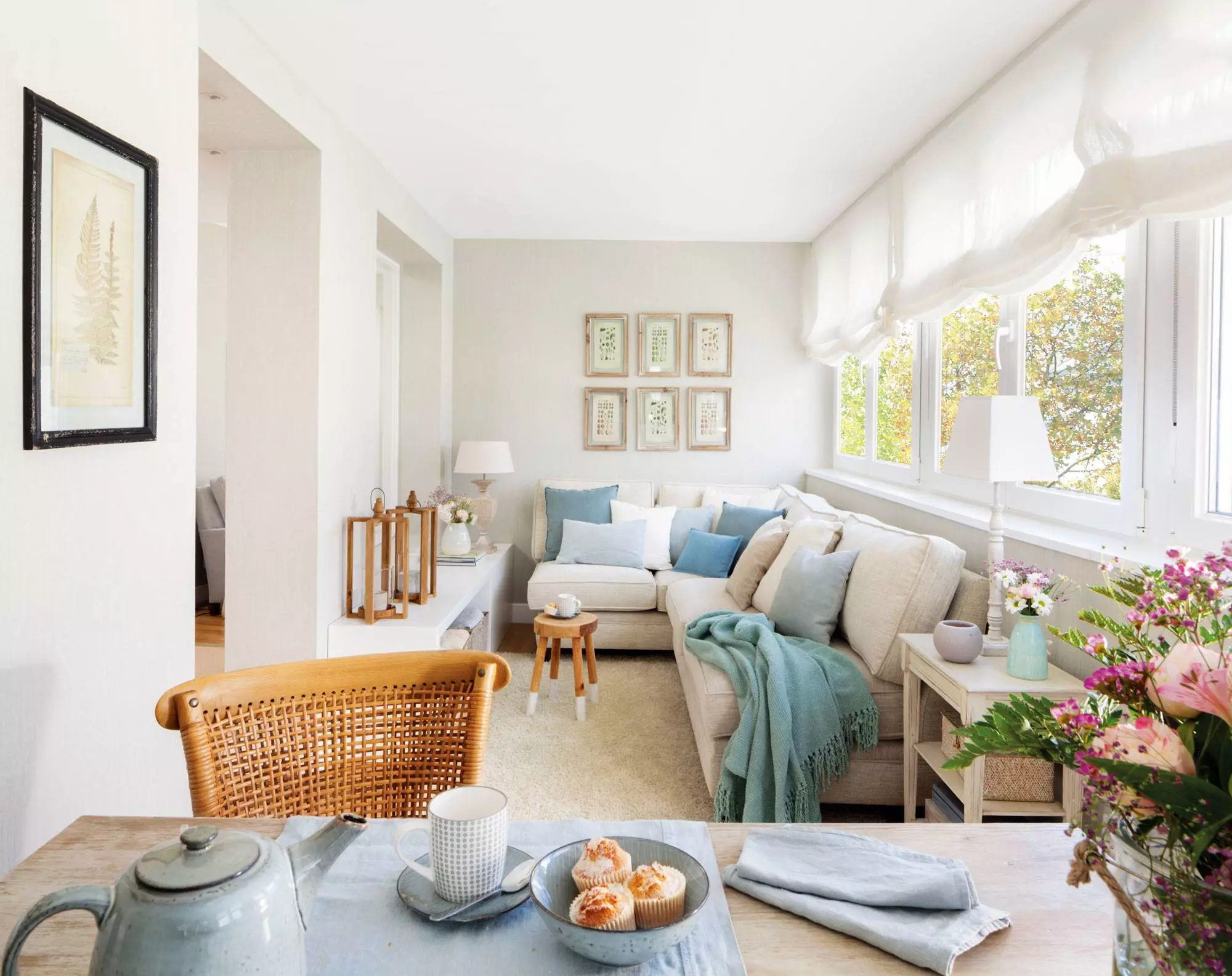 Living room with wall of windows and sofas with chaise longue