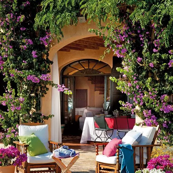 Living area with armchairs and folding table on the porch