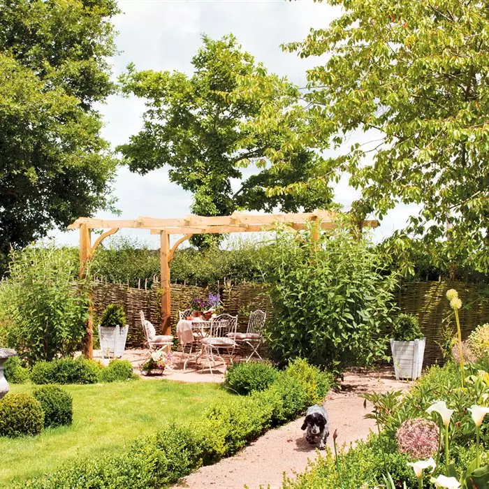 wooden pergola, table and chairs in the garden