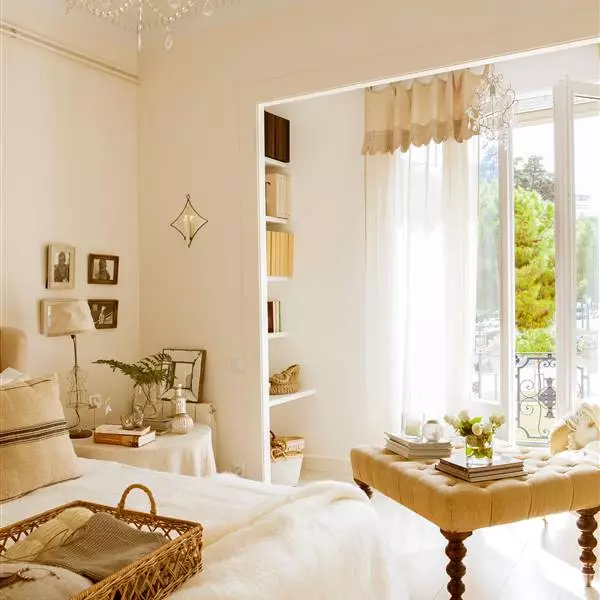 Classic white bedroom with chandelier and white painted wooden floor