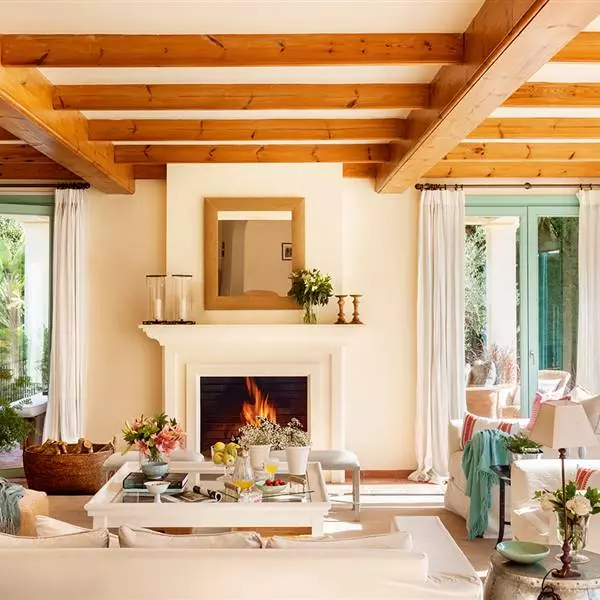 Living room with turquoise woodwork and a lit fireplace