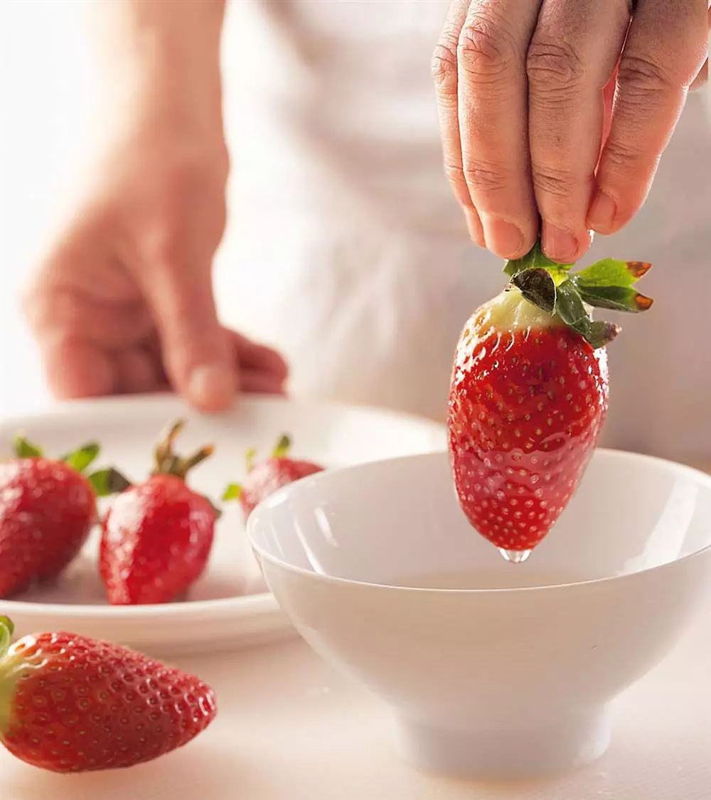 Detail of hands washing strawberries