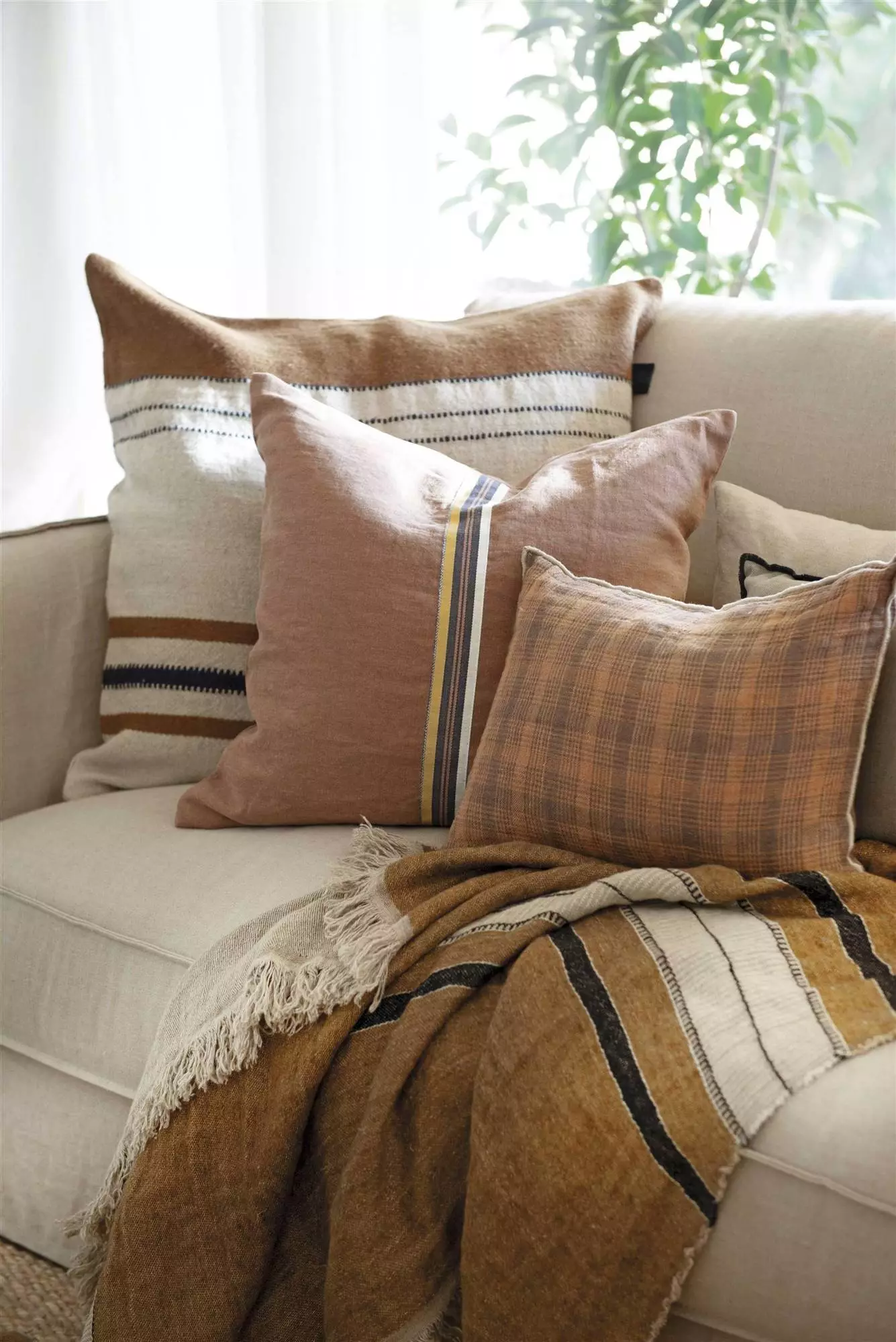 sofa-with-linen-and-striped-cushions-00531364