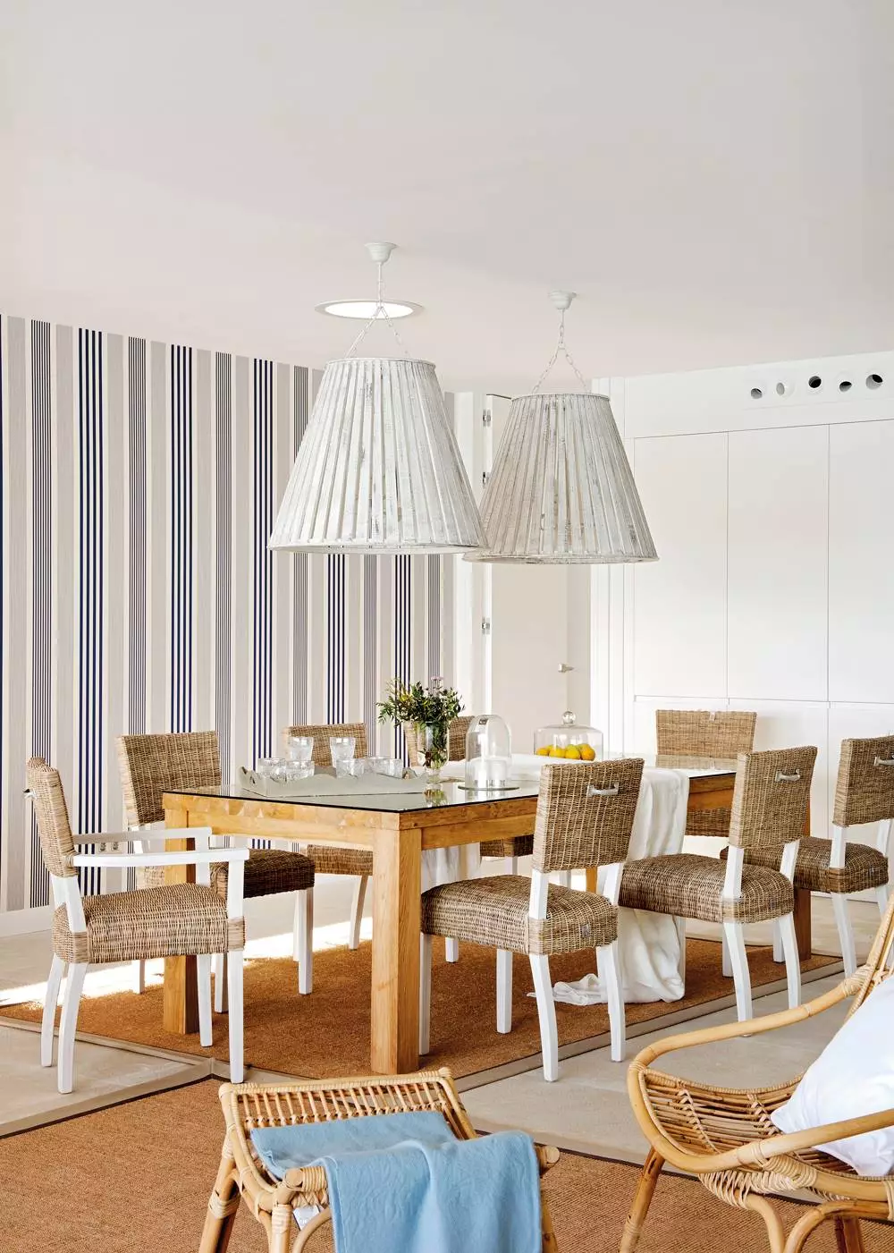 Appartement d'été salle à manger avec papier peint à rayures bleues et table avec plateau en bois