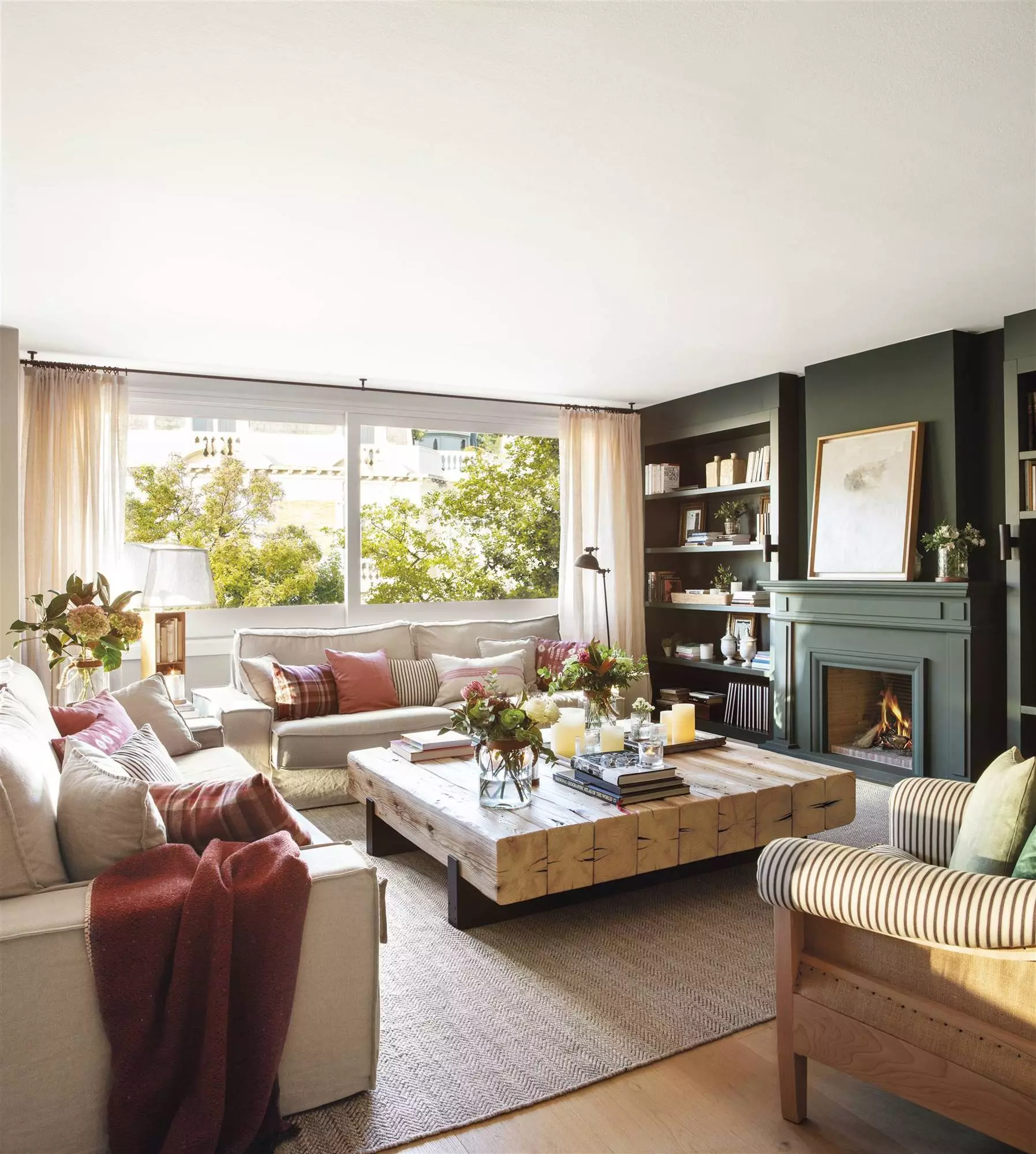 living room with bookcase and fireplace painted green and white sofas 00533430